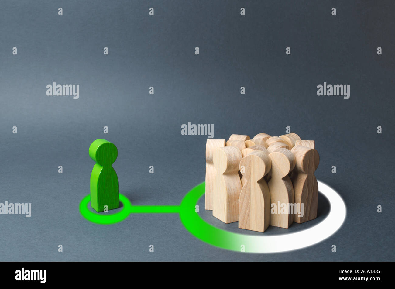 A green human figure influences a crowd of people. presentation of a ...