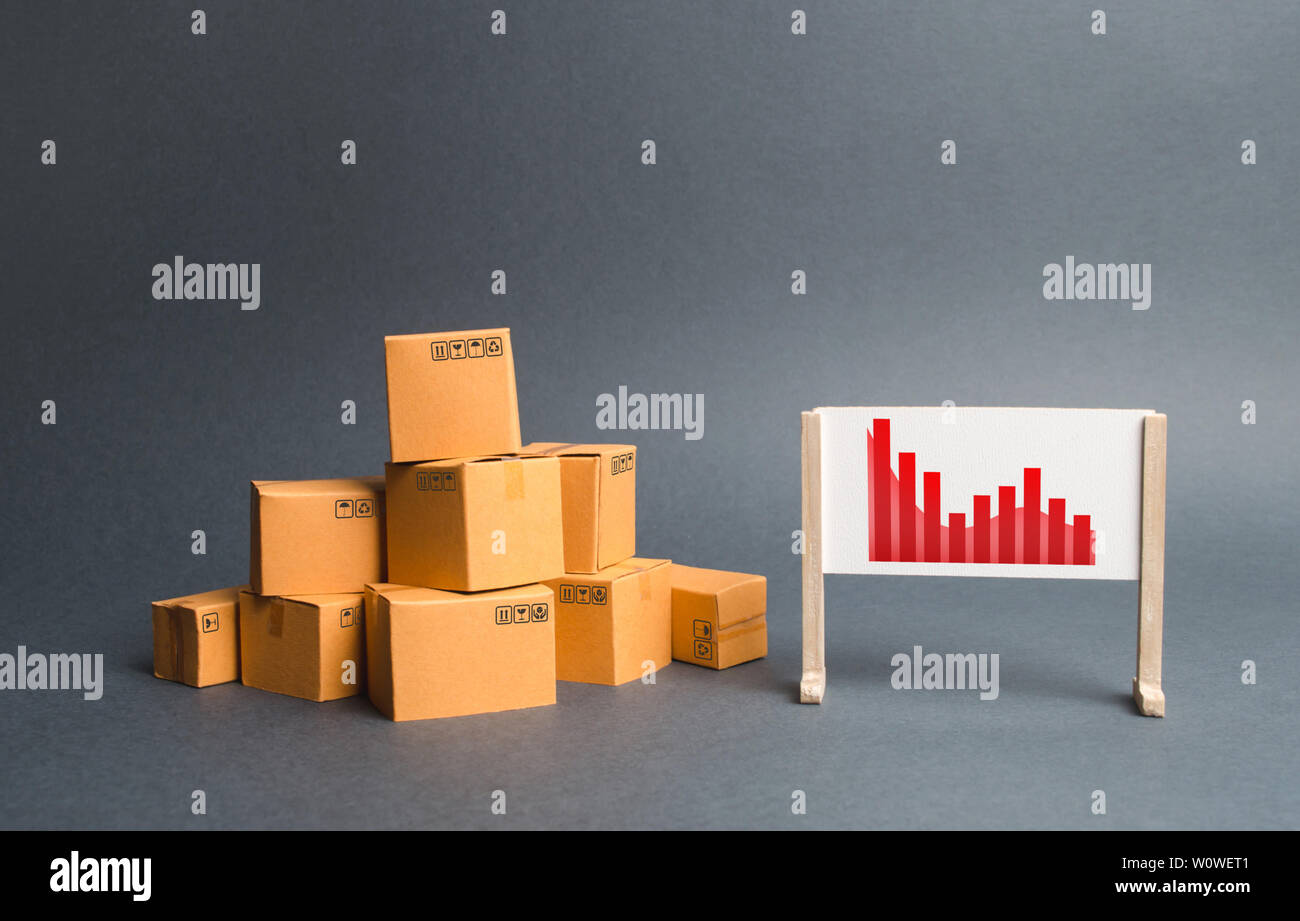 Stack of cardboard boxes and a stand with information chart. rate ...