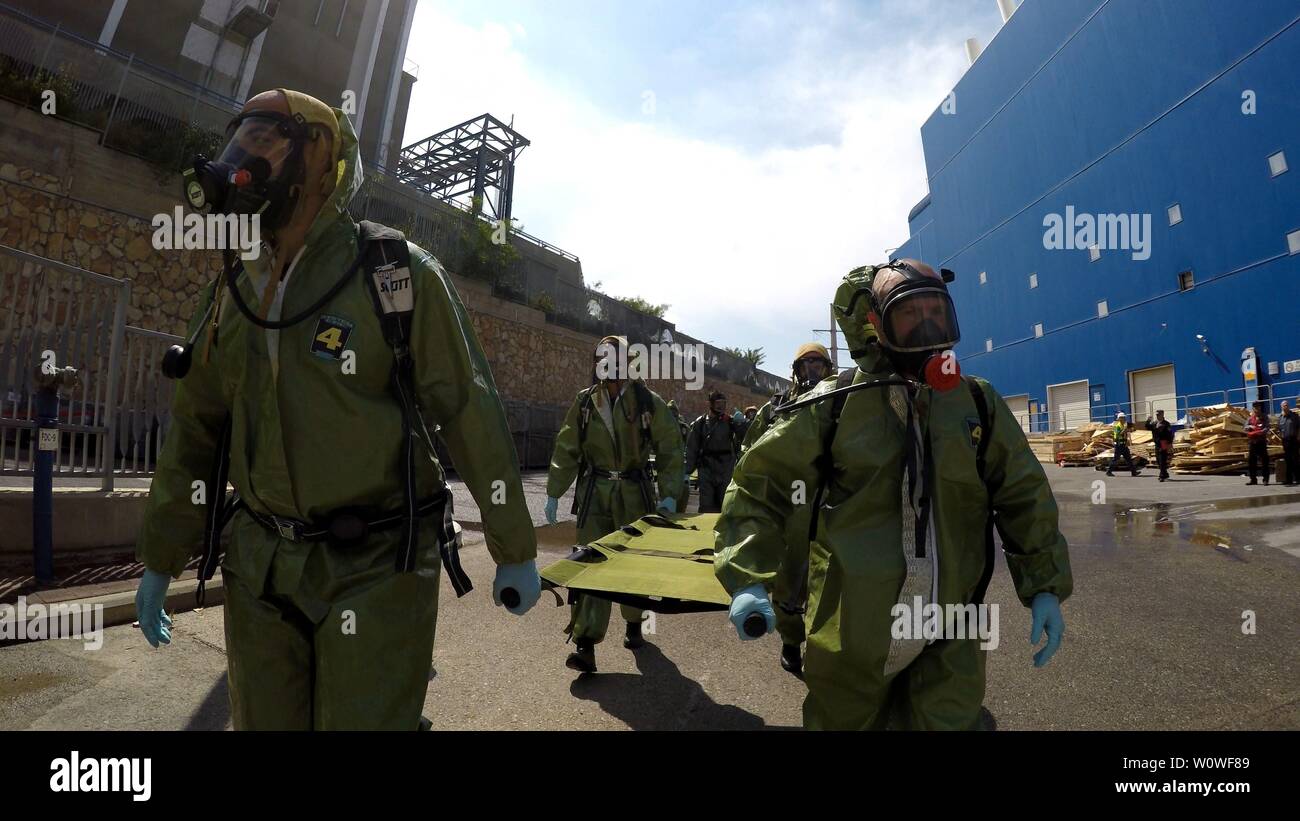 Soldiers carry stretchers to help injured person after leak of ...