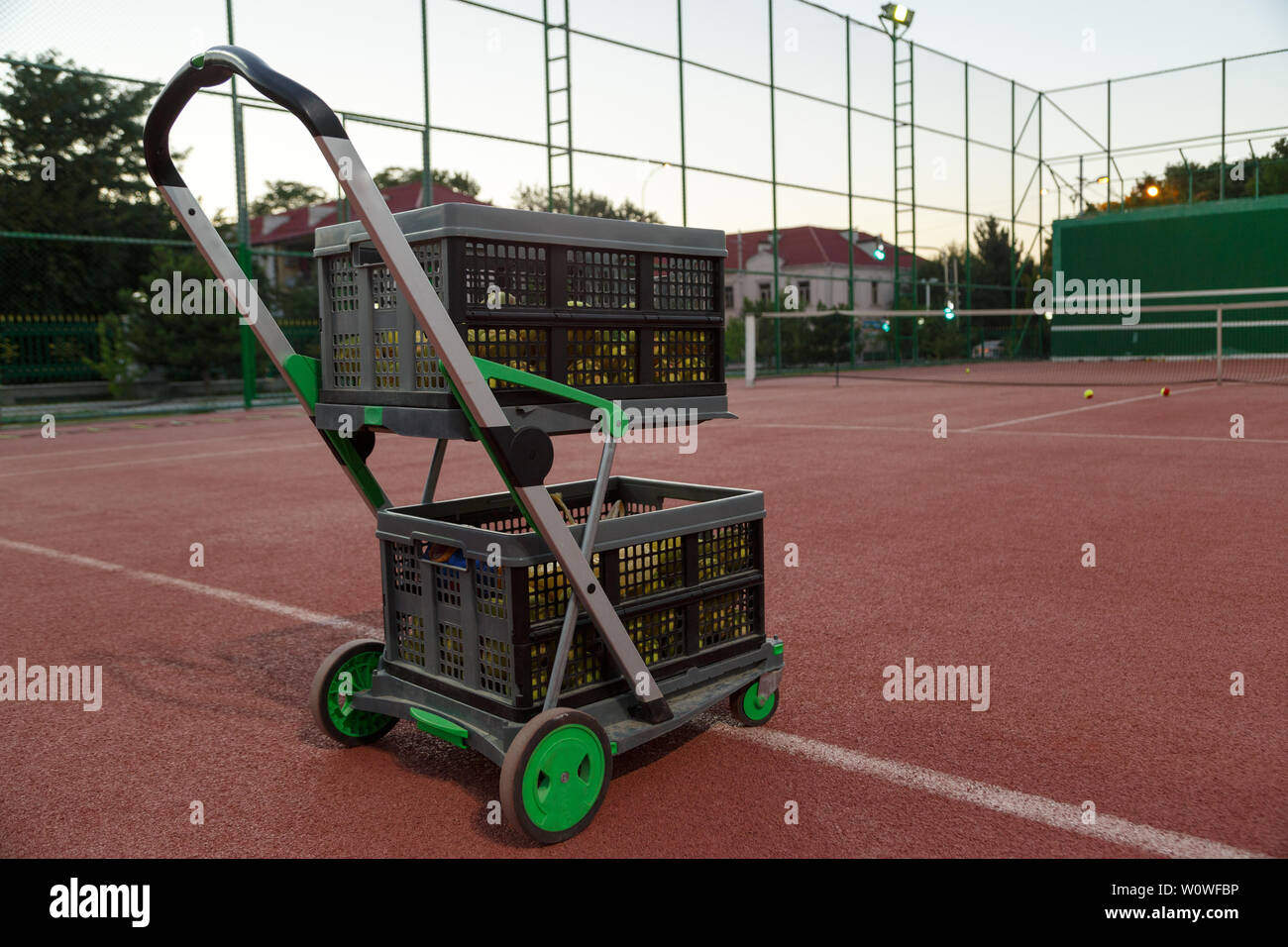 trolley for tennis balls on the tennis court in the evening Stock Photo ...