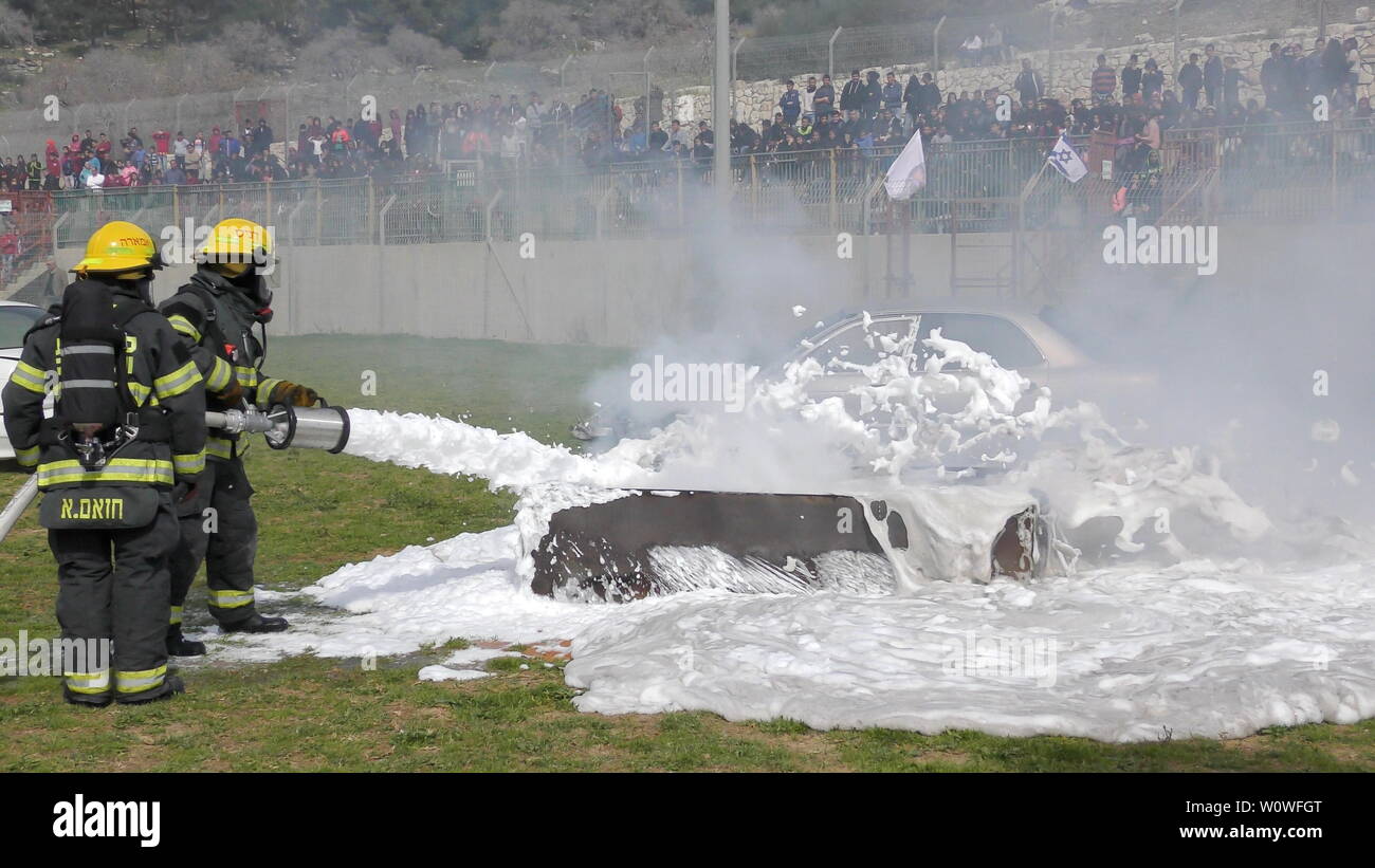 Firefighter from Northern Israel Fire Brigade dispense snow white foam ...