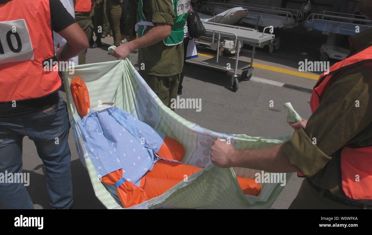 Paramedics and medical staff carrying injured mannequin victim of ...