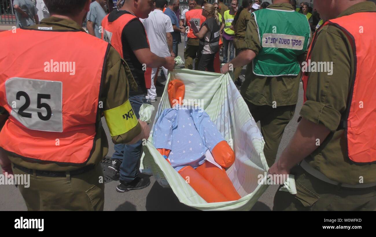 Paramedics and medical staff carrying injured mannequin victim of ...