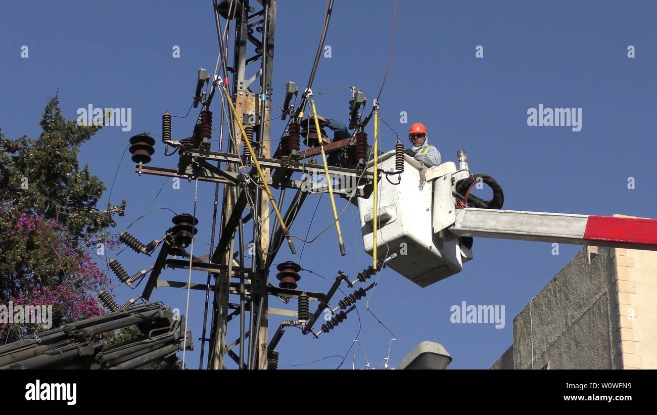 Electricians of the Israeli Electric Co fixing high voltage electrical ...