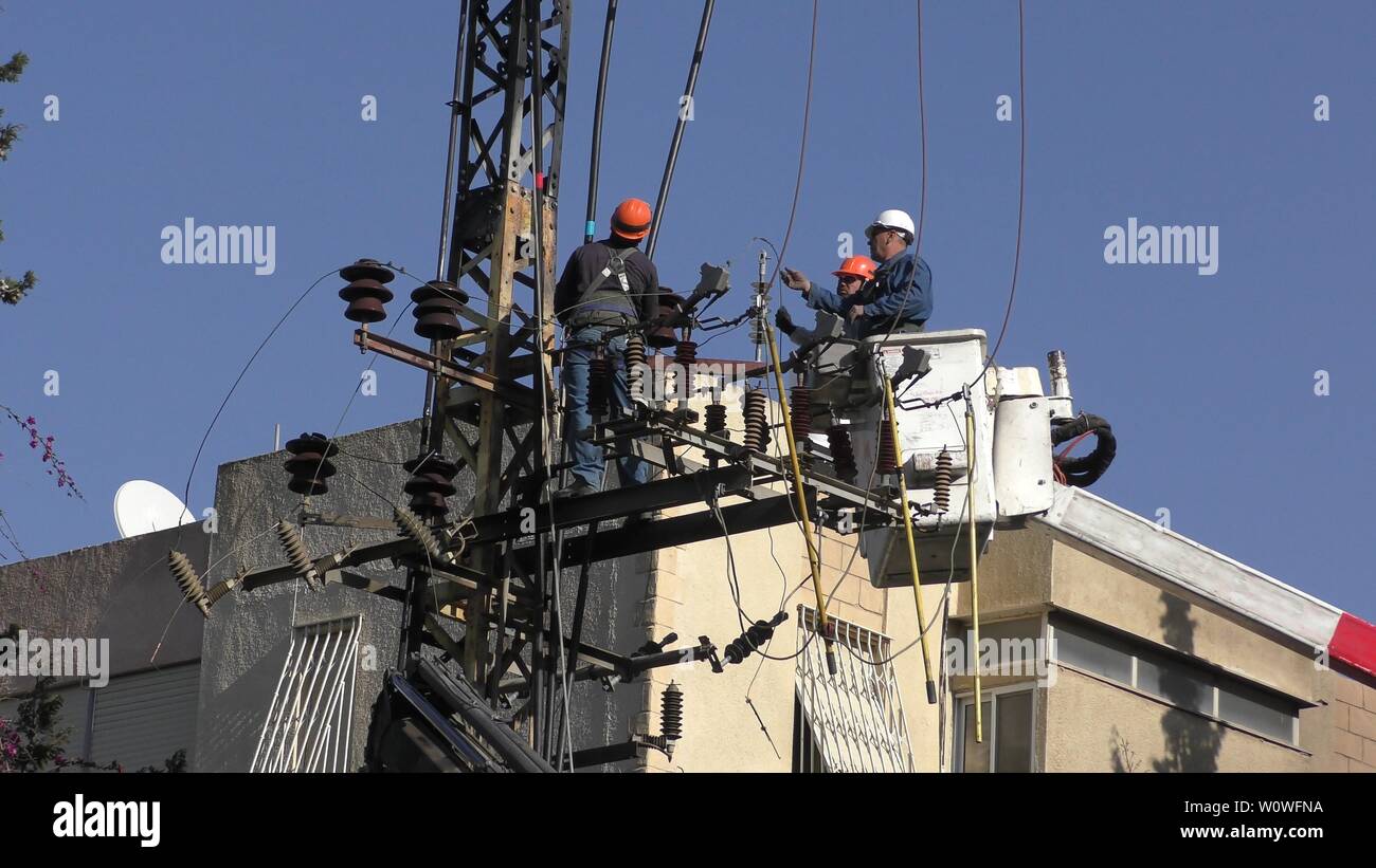 Electricians of the Israeli Electric Co fixing high voltage electrical ...