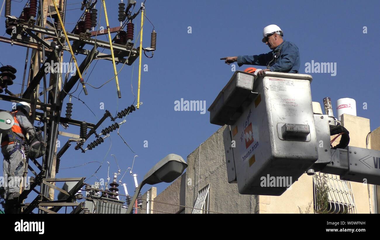Electricians of the Israeli Electric Co fixing high voltage electrical ...