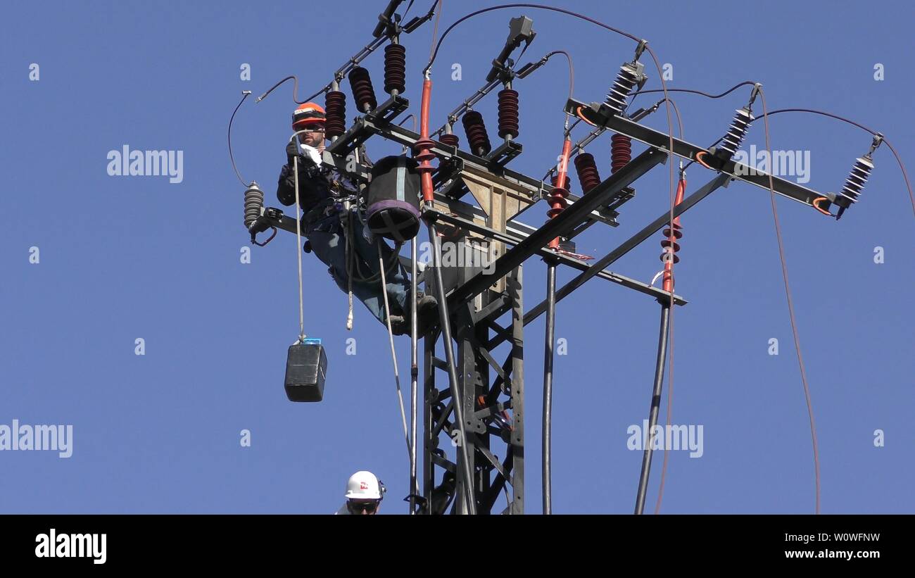 Electricians of the Israeli Electric Co get water while fixing high ...