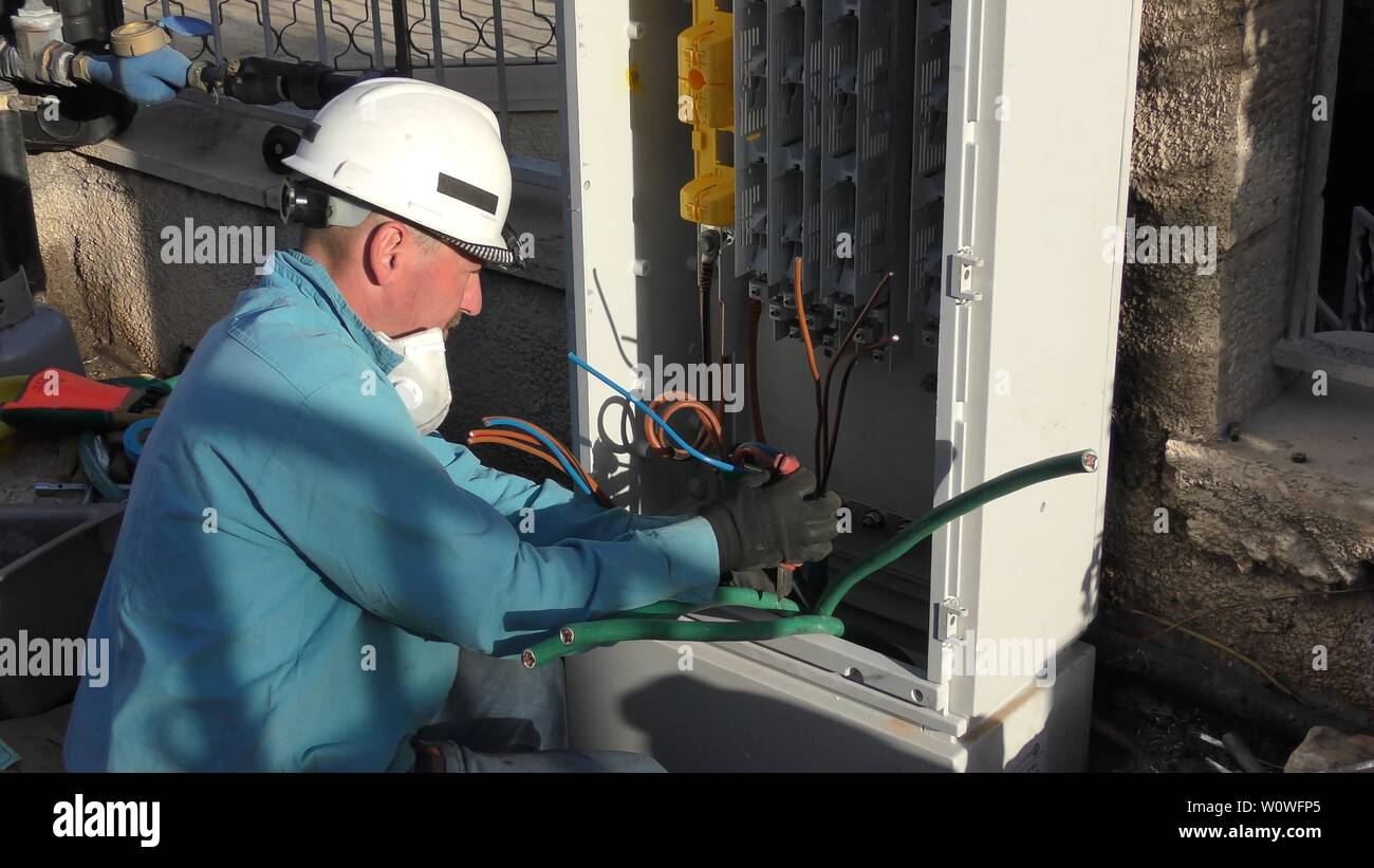 Engineers of the Israeli Electric Co fixing high voltage electrical ...