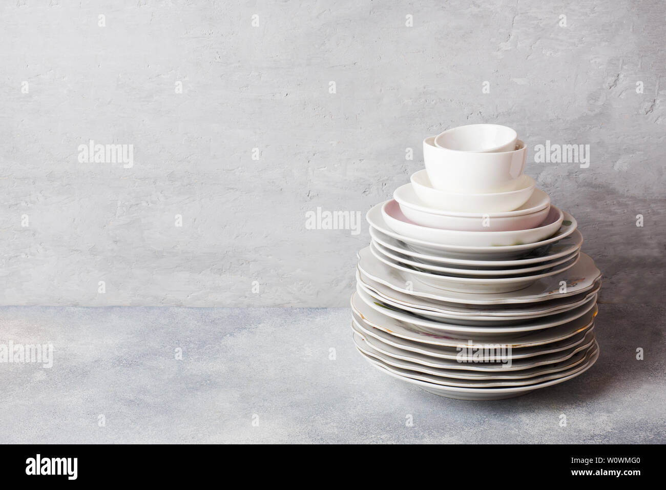 Stack of empty clean plates on a gray table with copy space Stock Photo ...