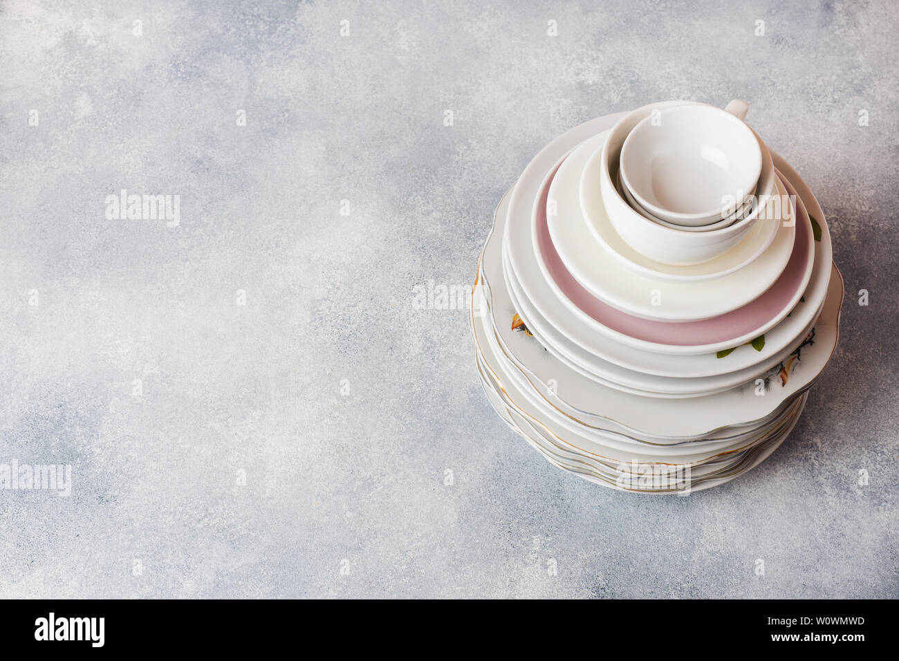 Stack of empty clean plates on a gray table with copy space Stock Photo ...