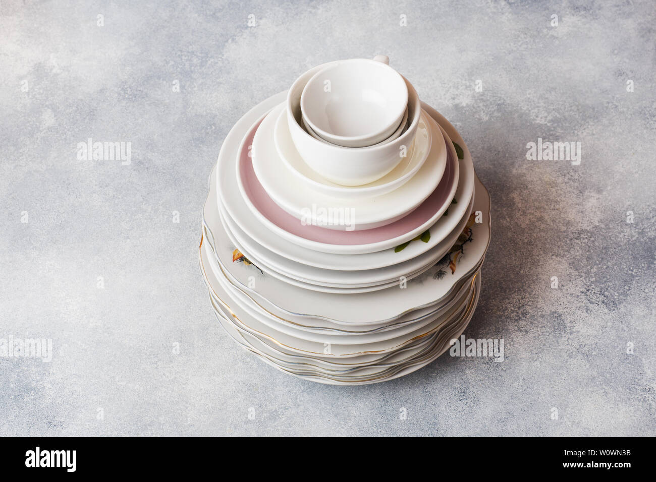 Stack of empty clean plates on a gray table with copy space Stock Photo ...