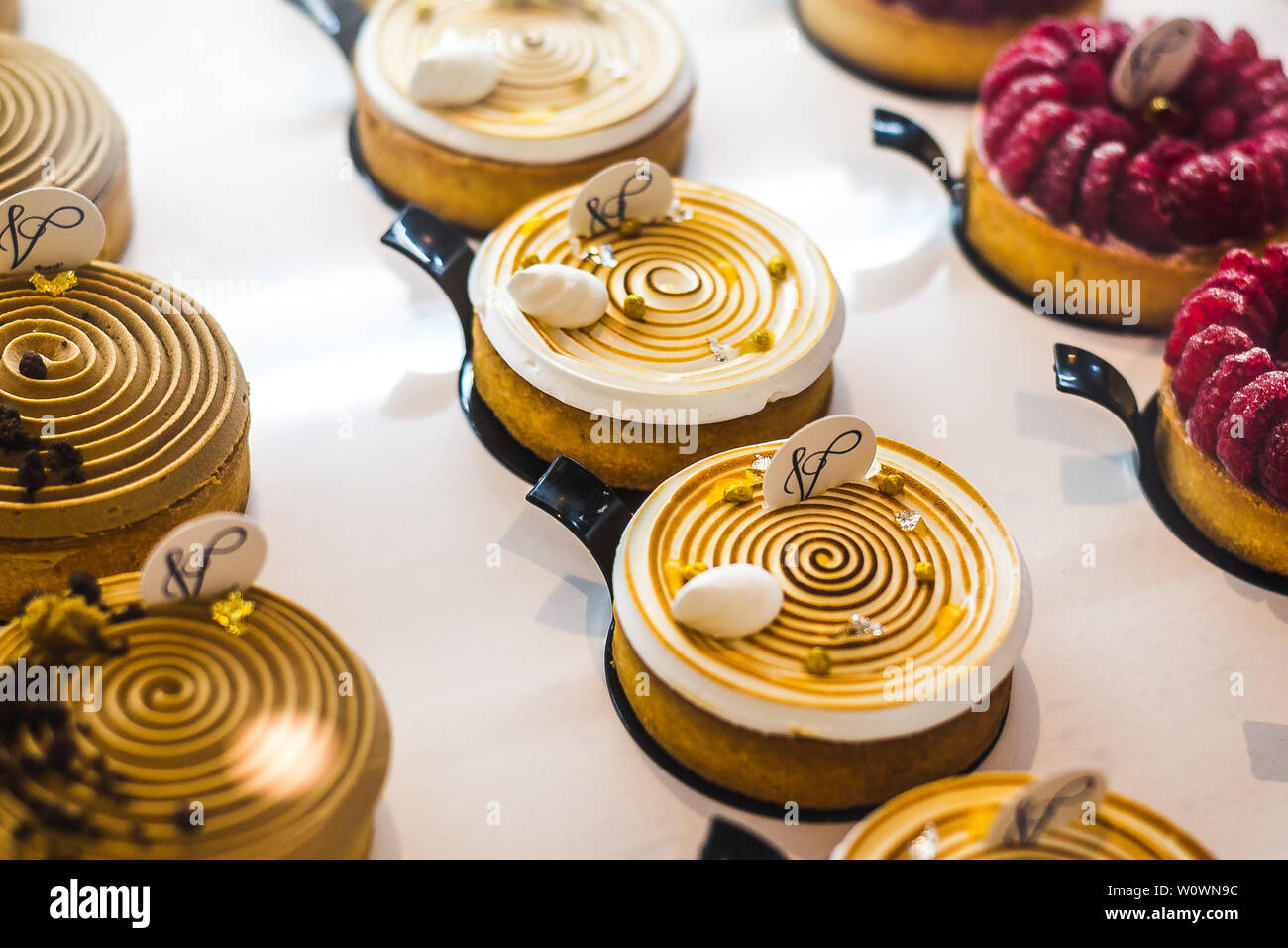 assorted beautiful French pastries and desserts on display for sale ...