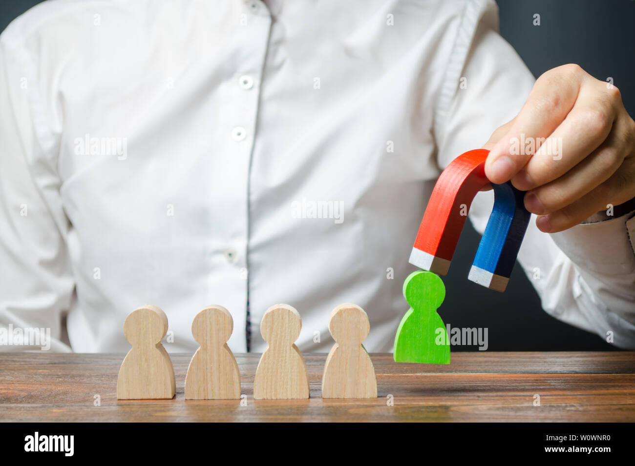 The businessman draws a green figure from the team with a magnet ...