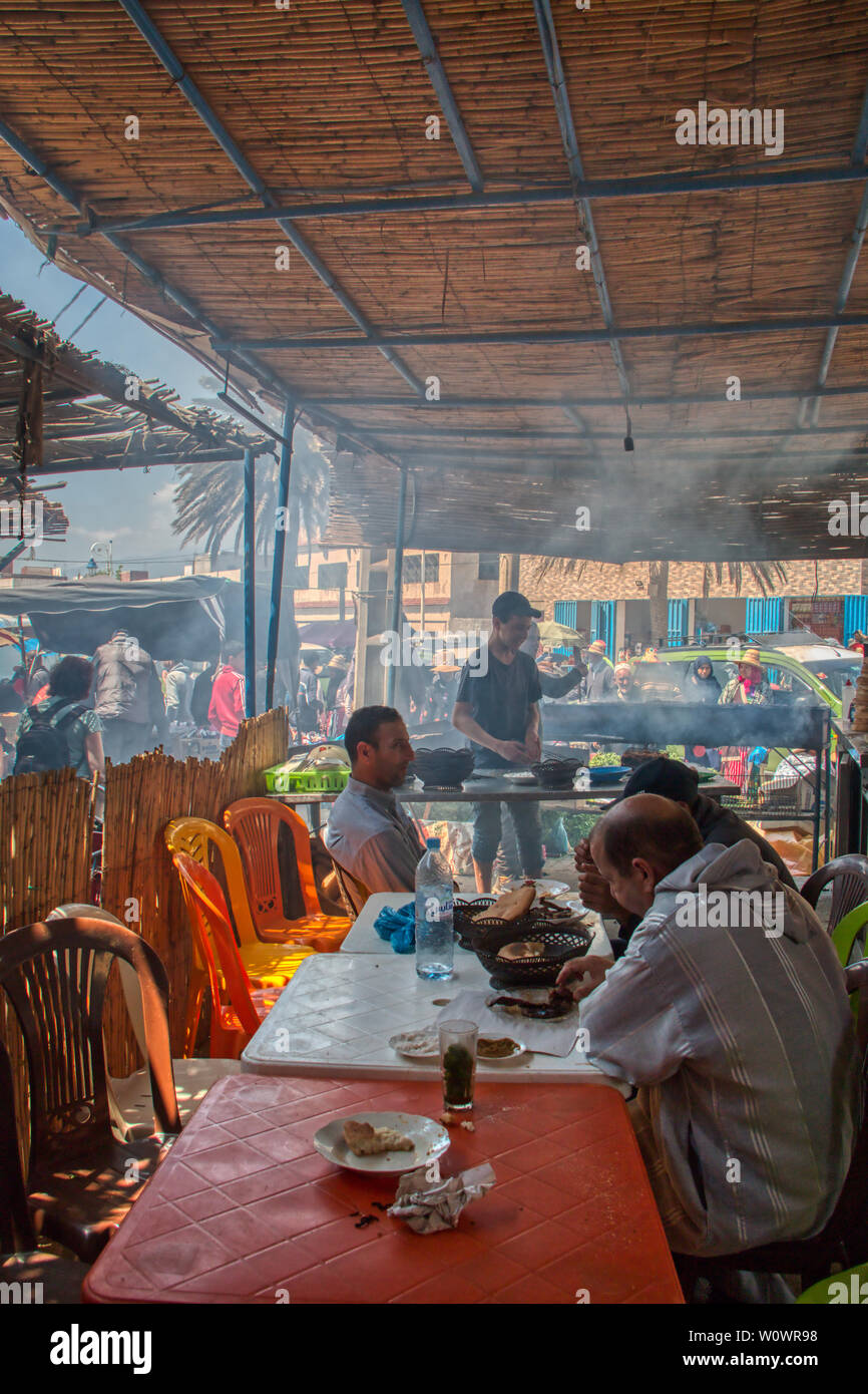 Oued Laou, Tetouan, Morocco - May 4, 2019: Men eating at a traditional ...