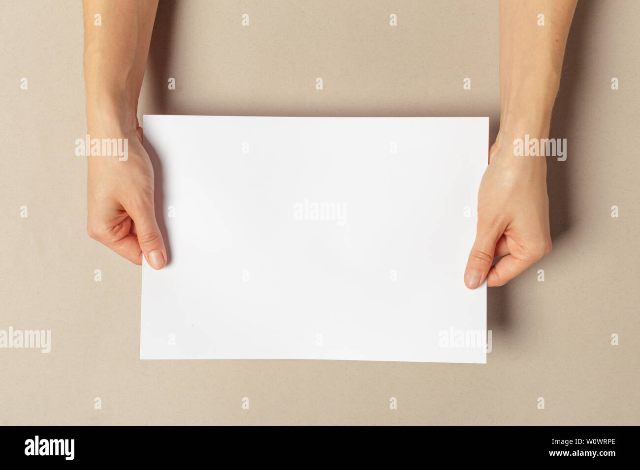 Hand holding papers a4 size Stock Photo - Alamy