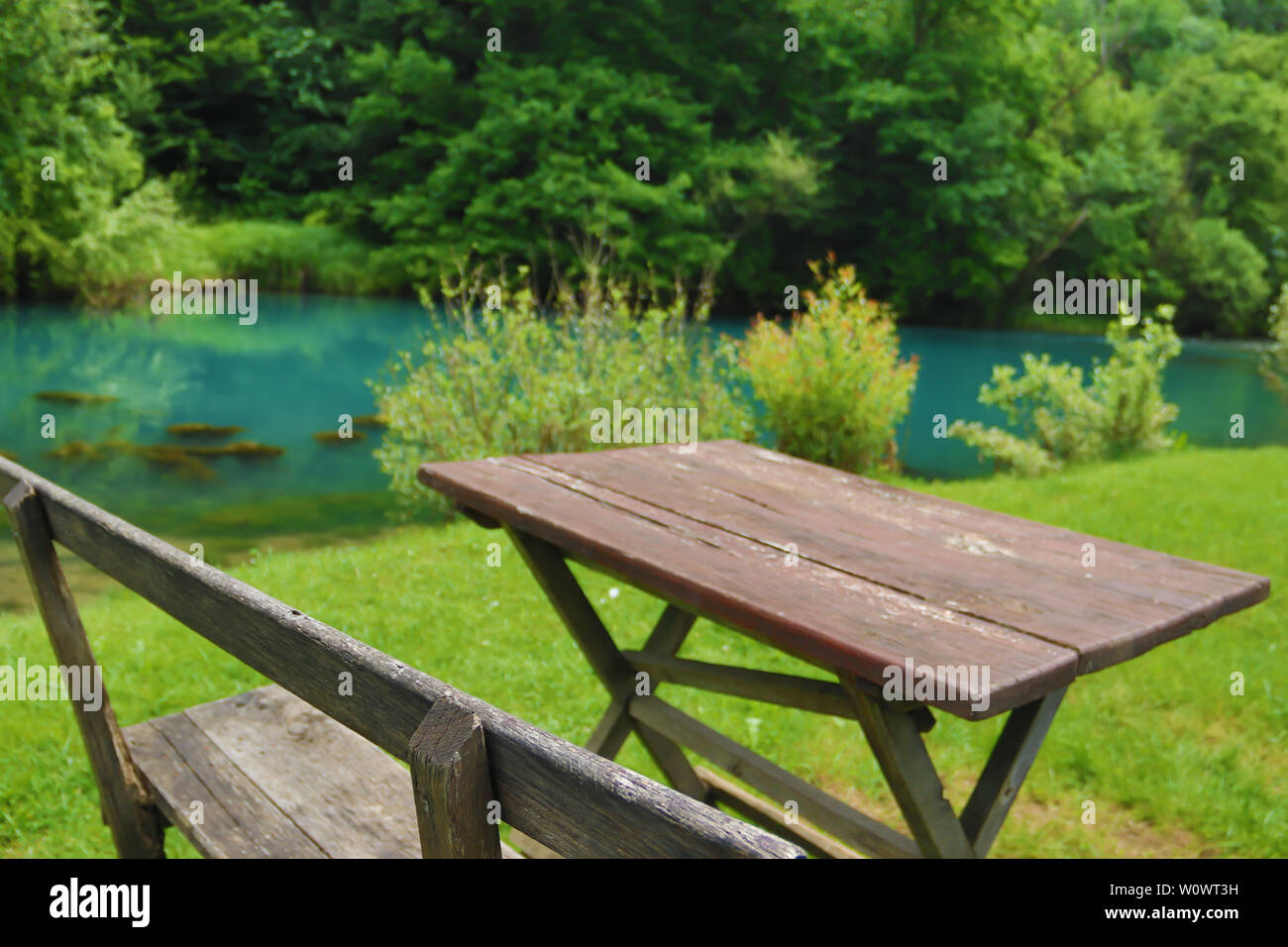 Home made wooden bench and table next to very scenic river bank Stock ...