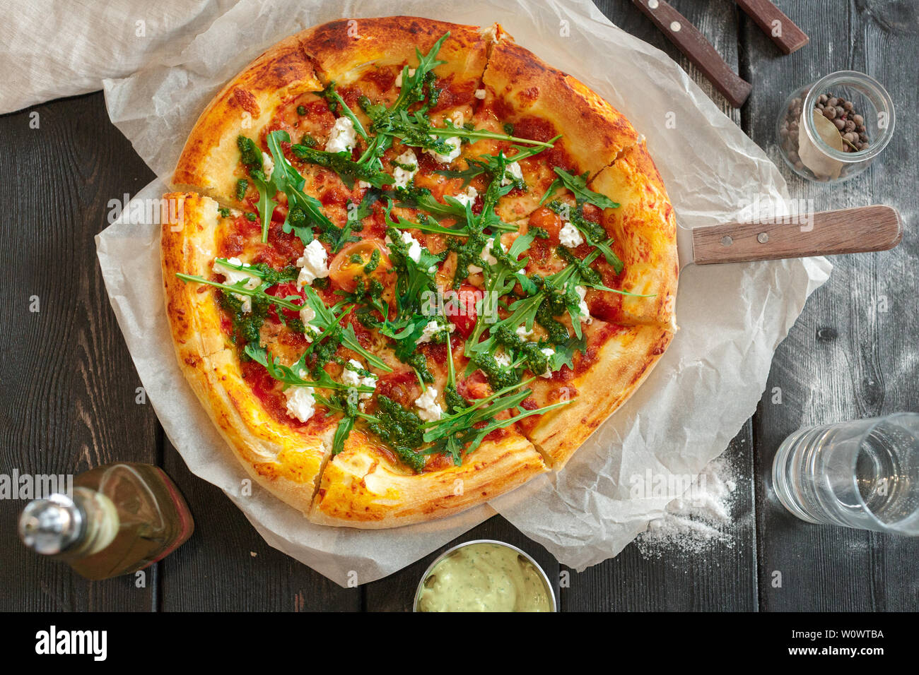 delicious italian pizza served on wooden table top view Stock Photo - Alamy