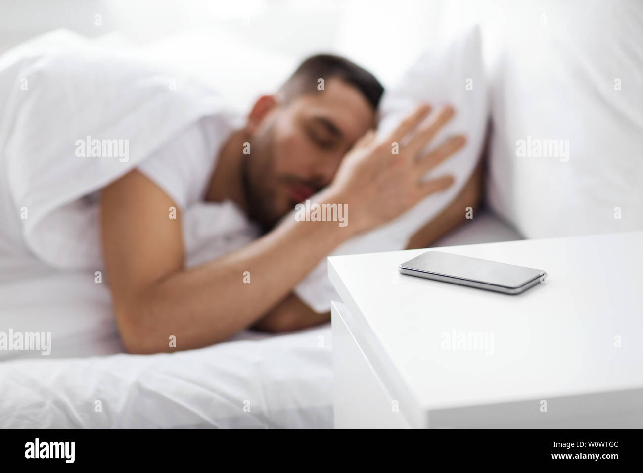 Mobile phone on bedside table hi-res stock photography and images - Alamy