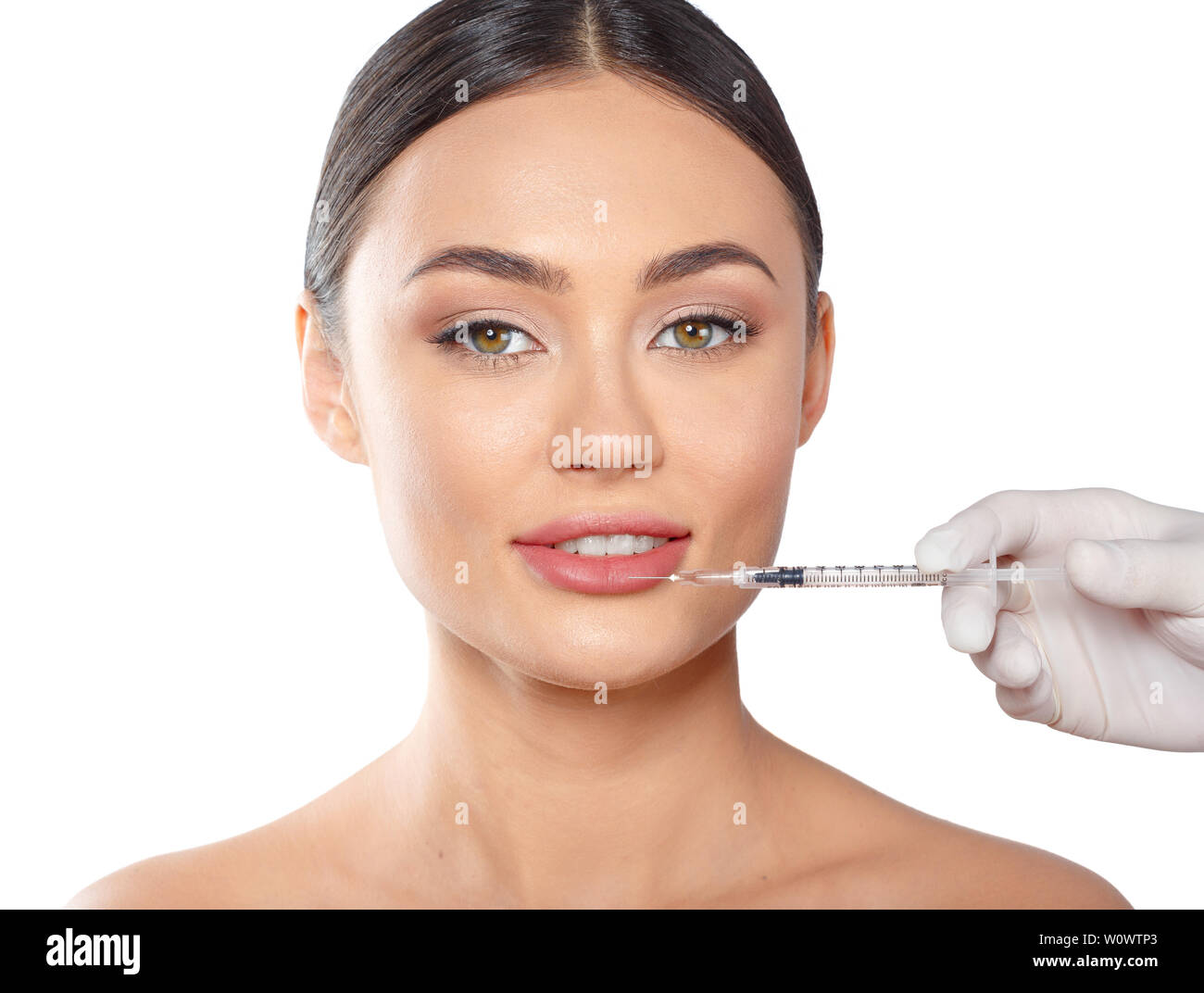 Portrait of an attractive young woman receiving botox treatment Stock ...