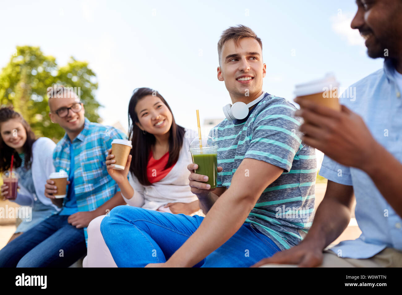 Friends drinking coffee juice talking hi-res stock photography and ...