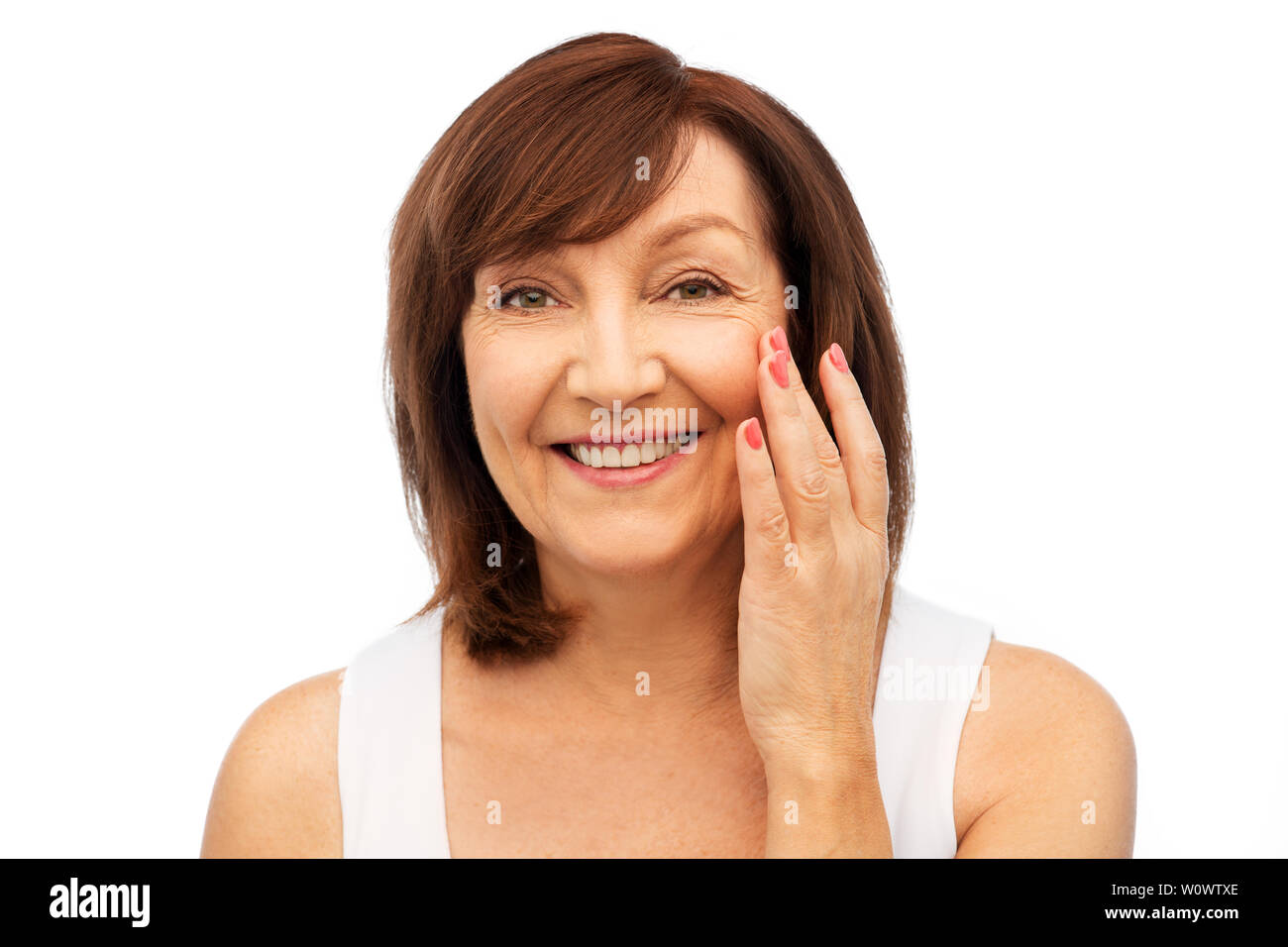 portrait of smiling senior woman touching her face Stock Photo - Alamy