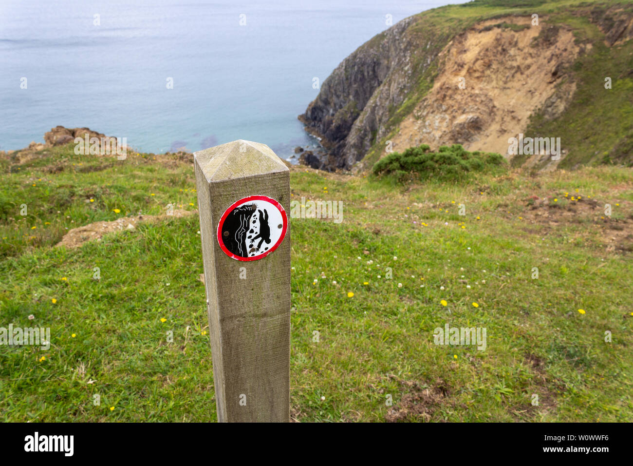 A warning sign on cliffs warning of the danger of falling. Includes a ...