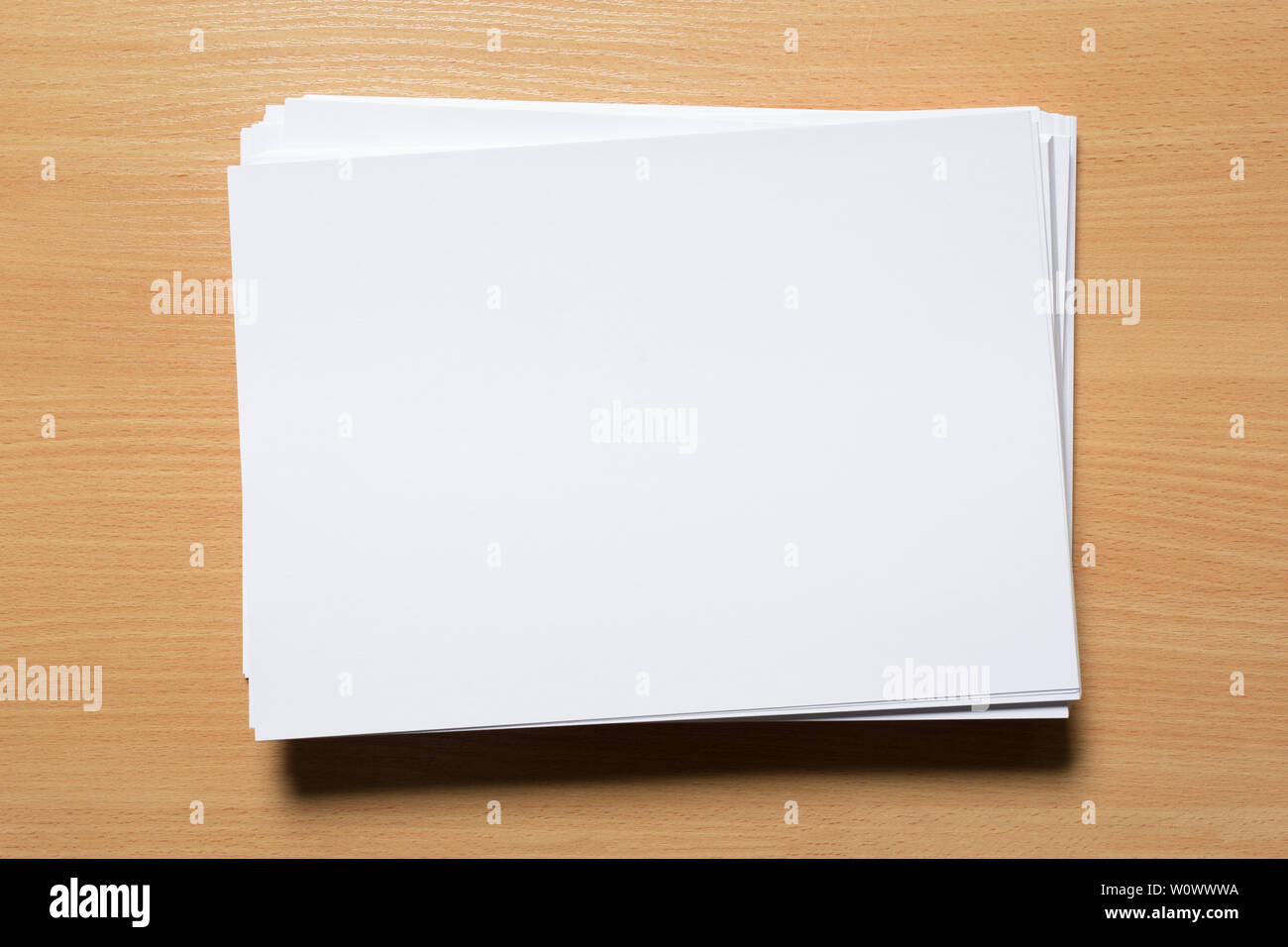 White business card on wooden table. Blank portrait A4 Stock Photo - Alamy