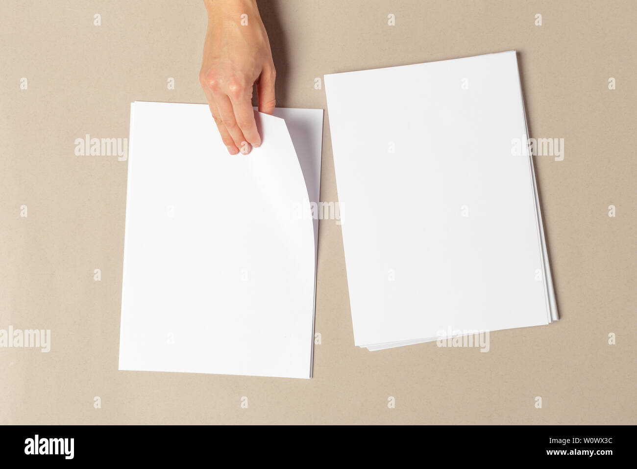 Hand holding papers a4 size Stock Photo - Alamy