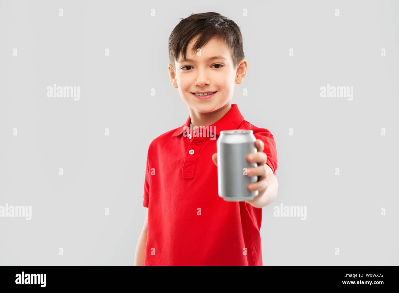 boy in red t-shirt drinking soda from tin can Stock Photo - Alamy