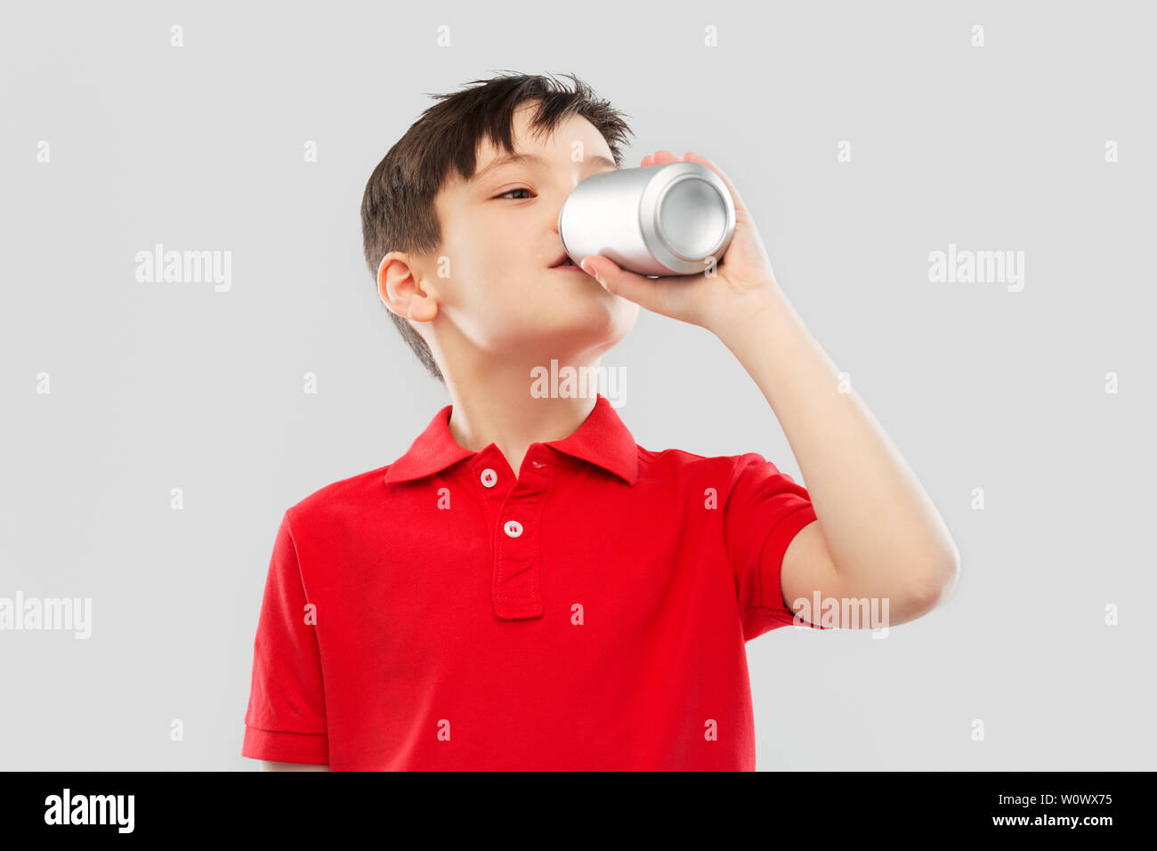 boy in red t-shirt drinking soda from tin can Stock Photo - Alamy