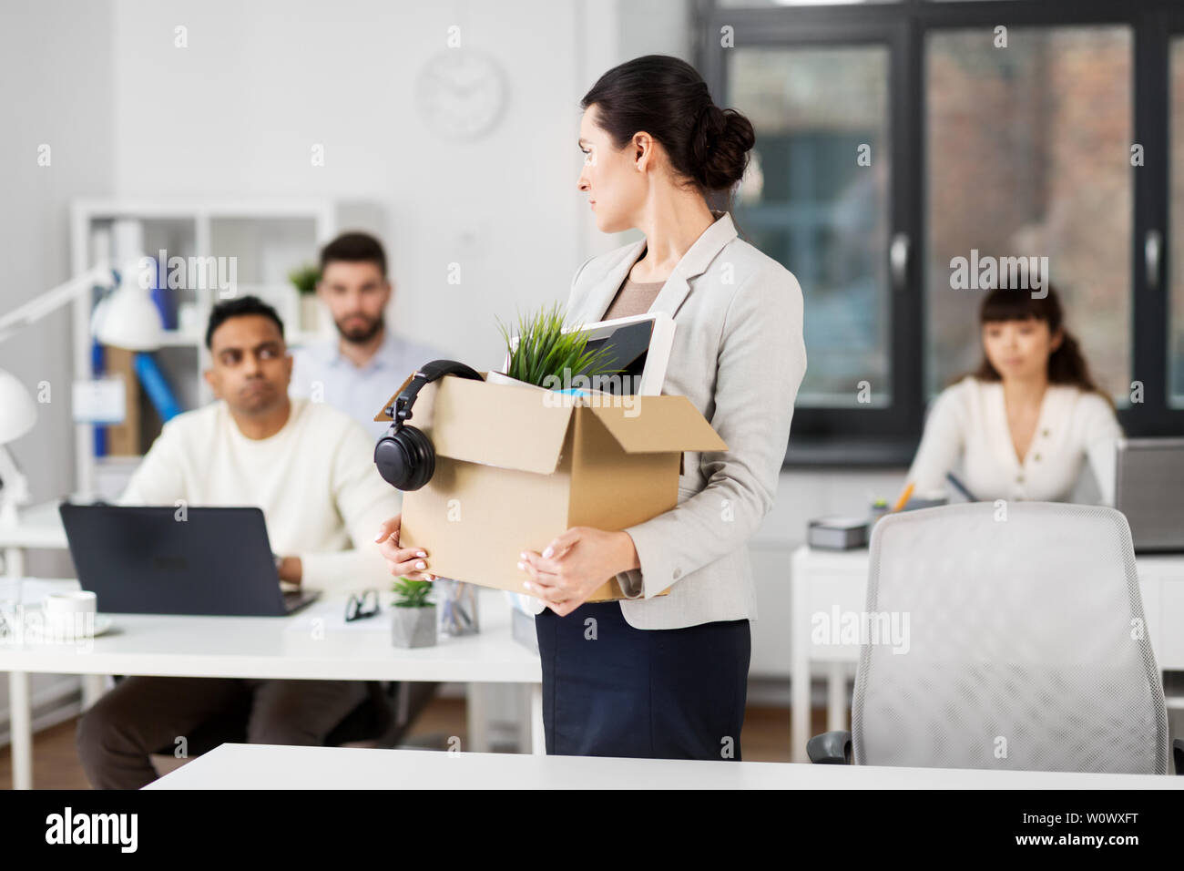 female office worker with box of personal stuff Stock Photo - Alamy