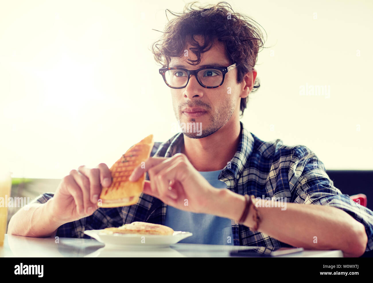 happy man eating sandwich at cafe for lunch Stock Photo - Alamy