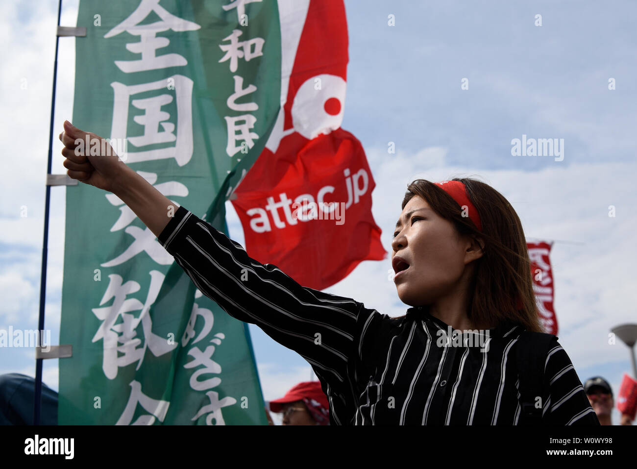 Osaka, Japan. JUNE 28, 2019 - A protestor chants slogans during a ...