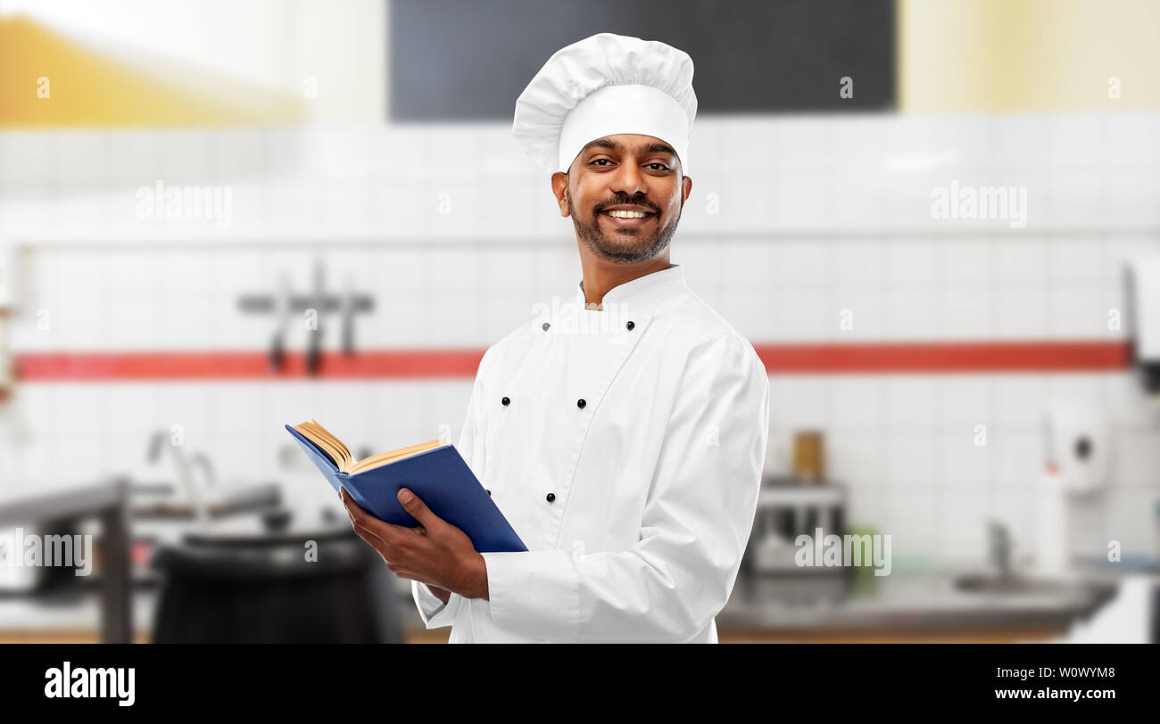 happy indian chef with cookbook at kitchen Stock Photo - Alamy