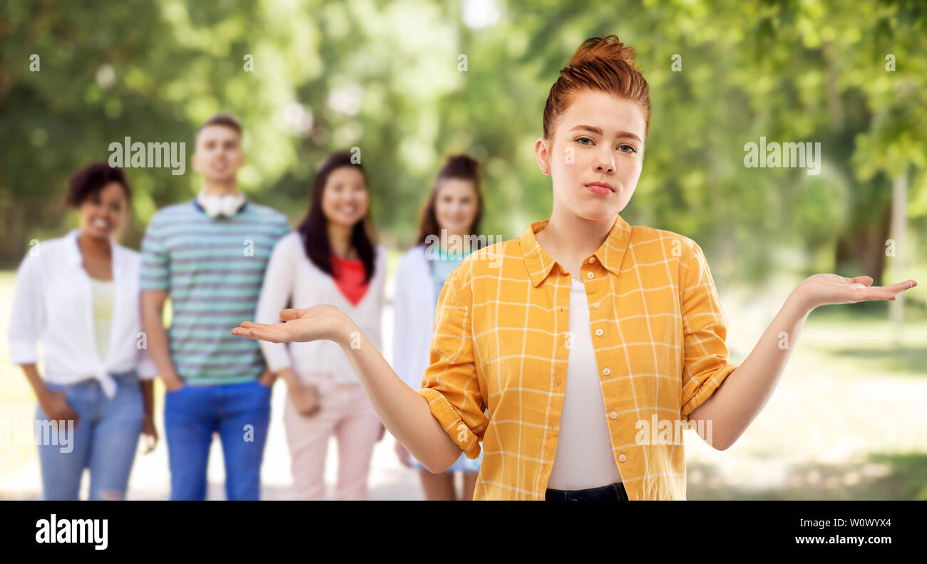 sad red haired teenage girl shrugging Stock Photo - Alamy