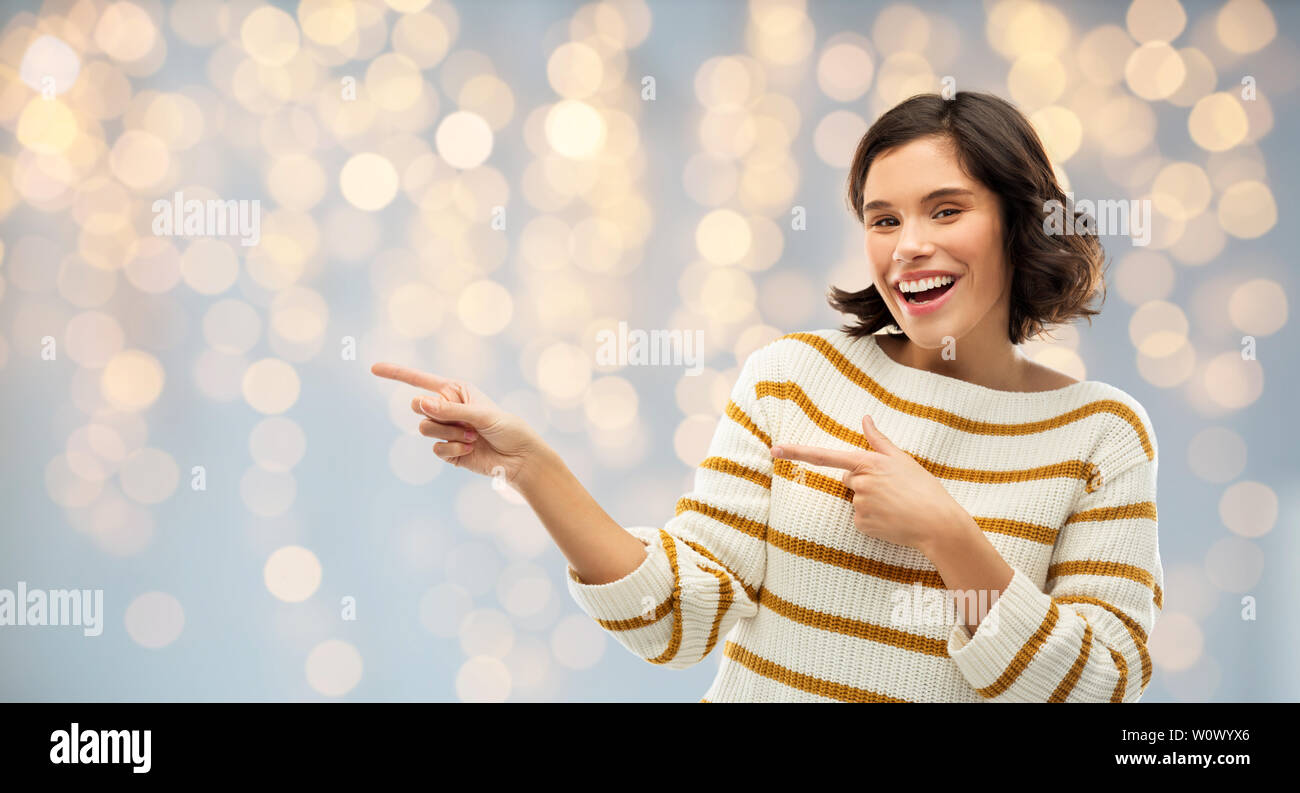 happy smiling woman pointing fingers to something Stock Photo - Alamy