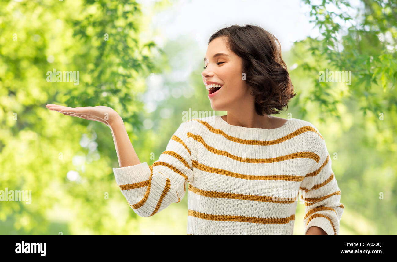 woman with empty hand over natural background Stock Photo - Alamy