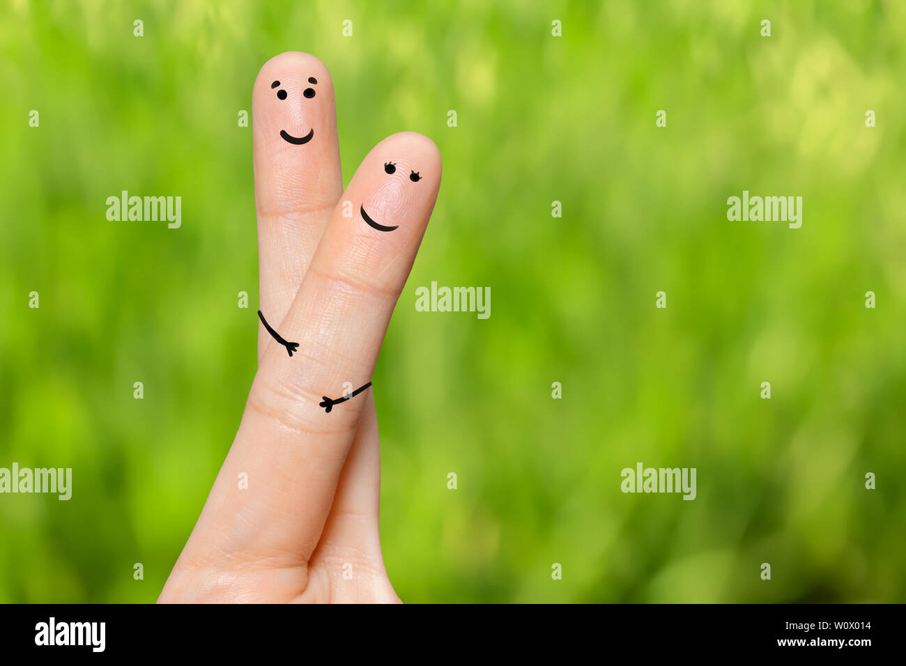 Human hand fingers with funny painted emoticons. People relationships ...