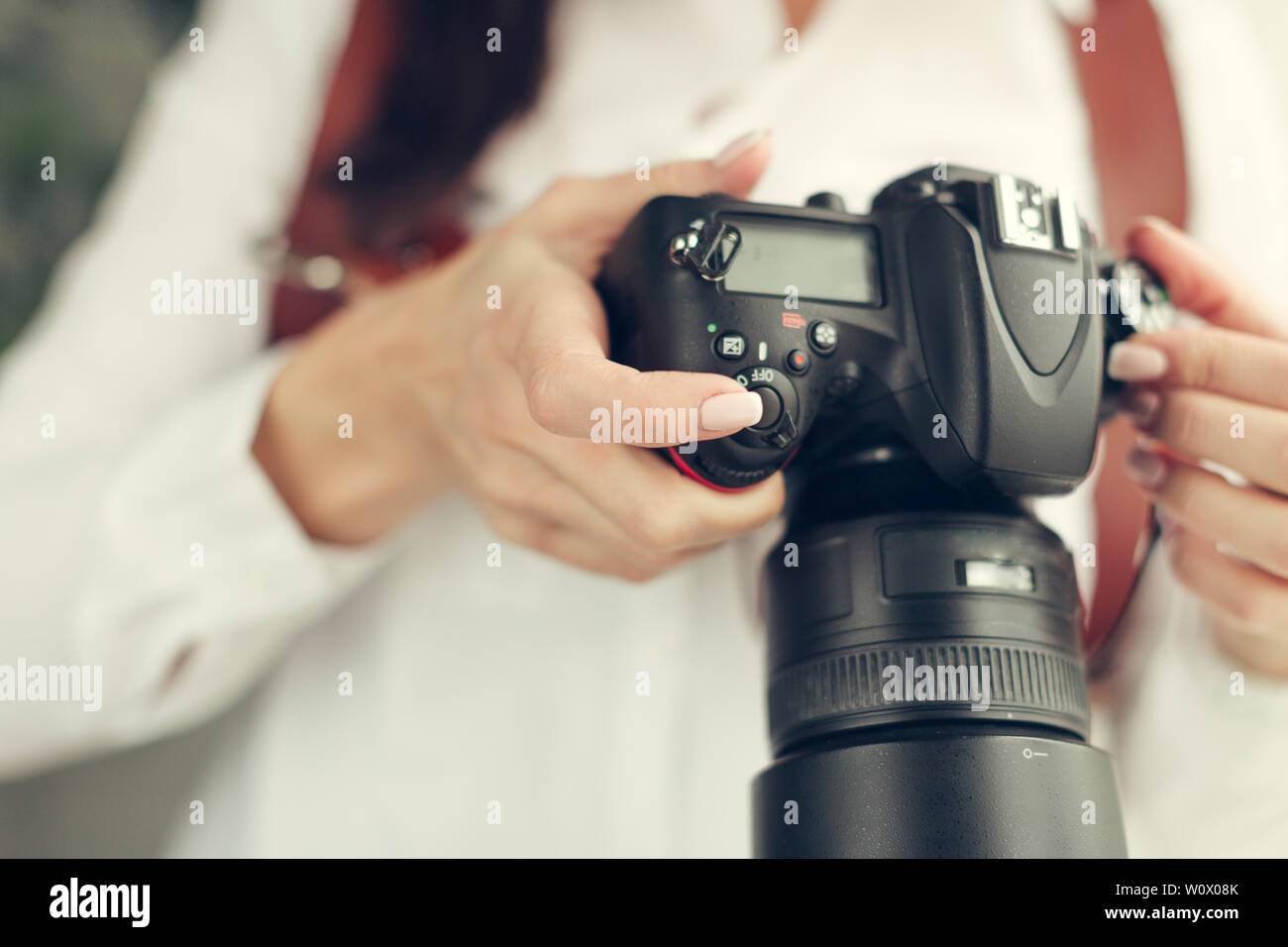 Pretty woman is a professional photographer with dslr camera Stock ...