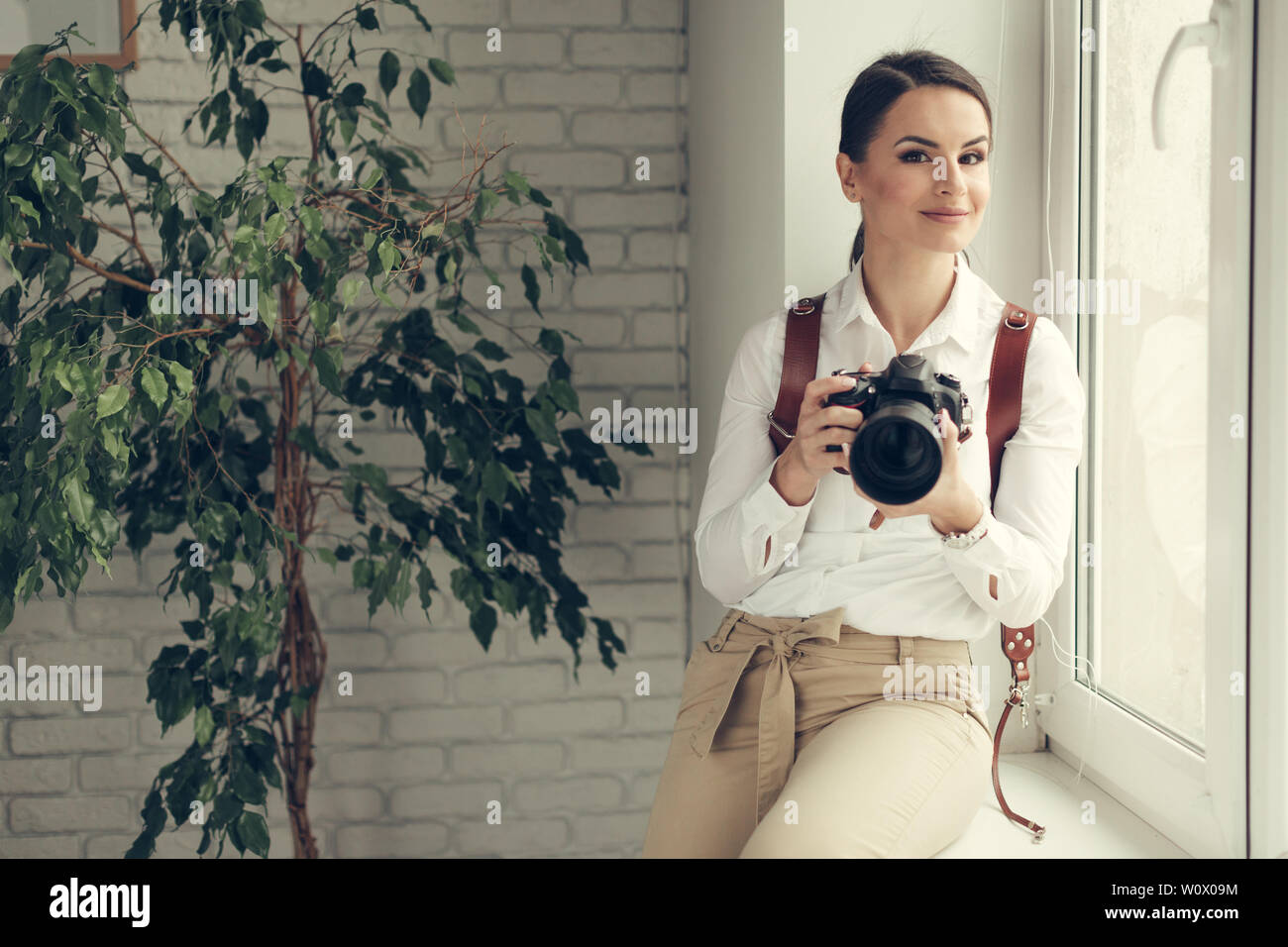 Pretty woman is a professional photographer with dslr camera Stock ...