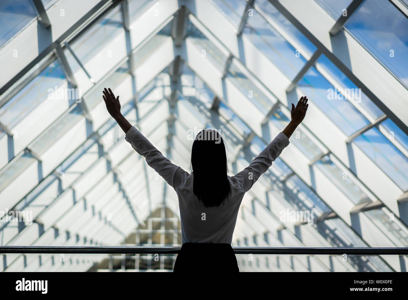 Successful Woman. Happy Young Woman Rising Hands Up To The Sky. In big ...