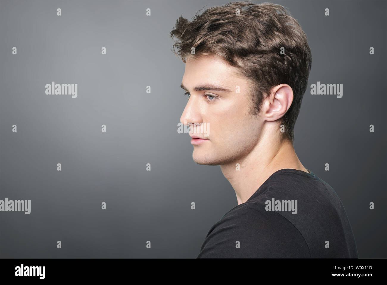 Puzzled thoughtful young man curiously looking at camera Stock Photo ...
