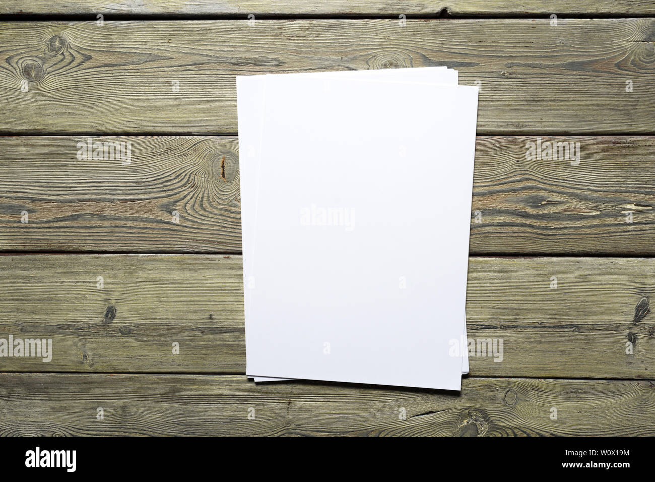 White business card on wooden table. Blank portrait A4 Stock Photo - Alamy