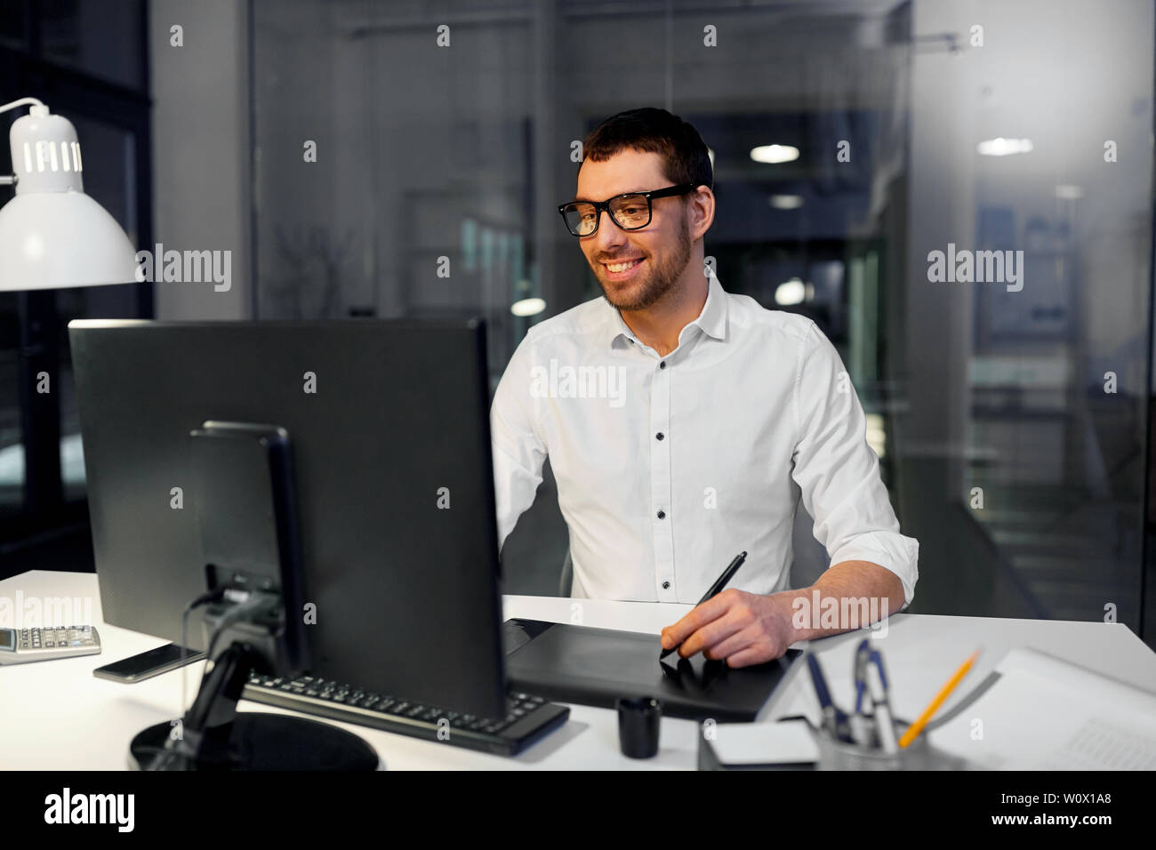 designer with computer and pen tablet at office Stock Photo - Alamy