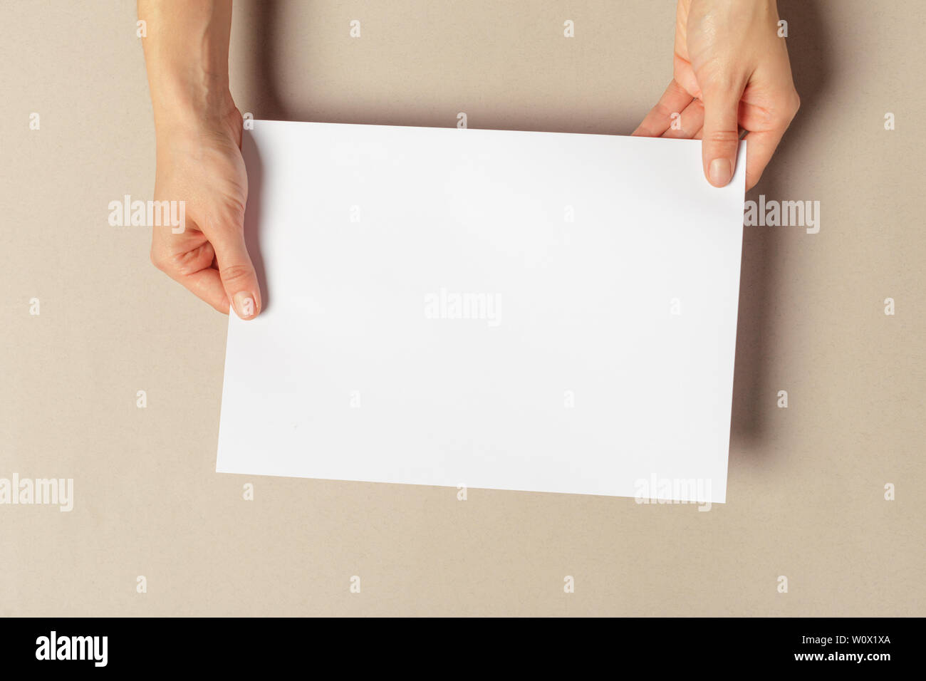 Hand holding papers a4 size Stock Photo - Alamy