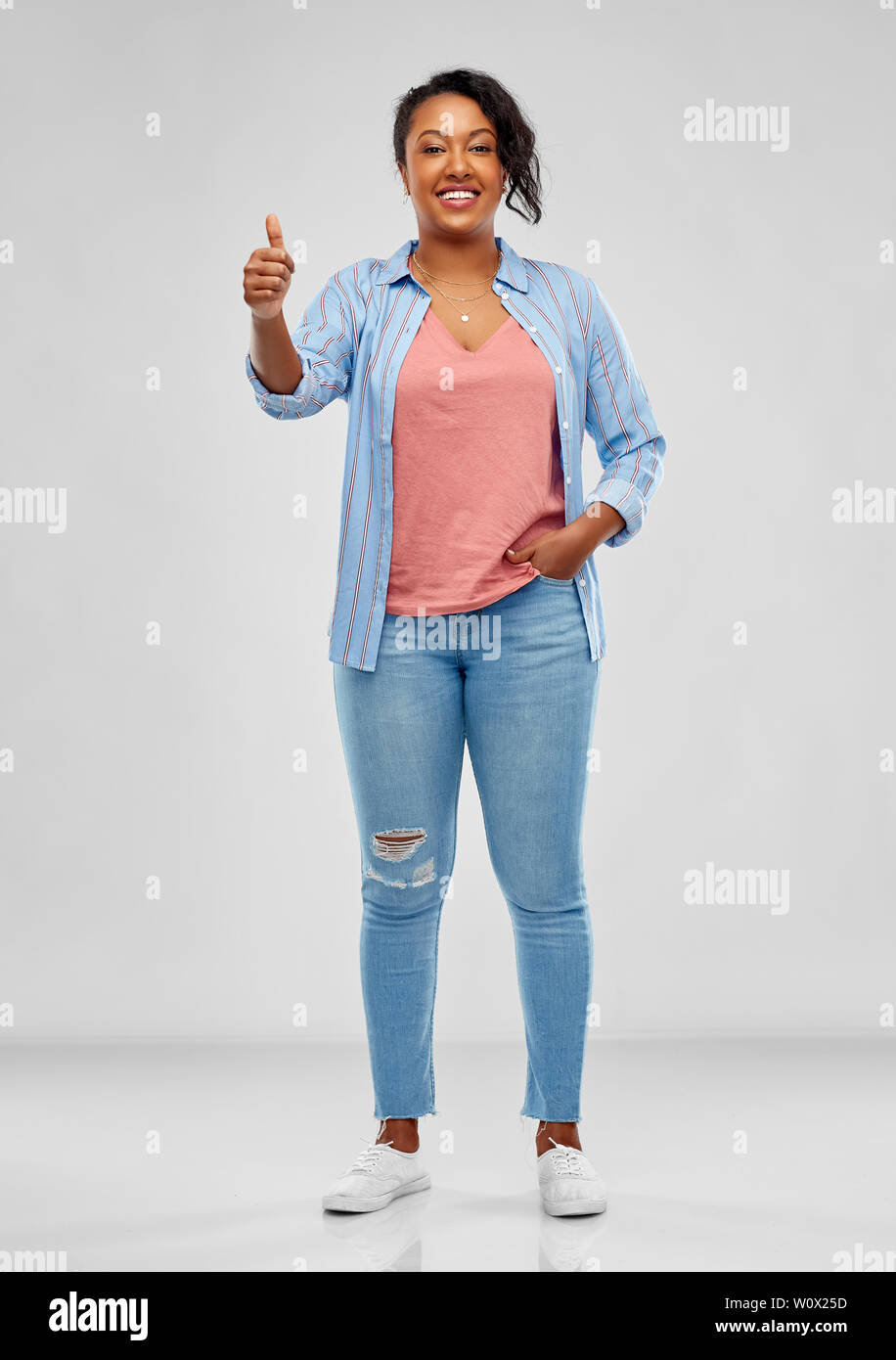 African woman showing thumbs up hi-res stock photography and images - Alamy