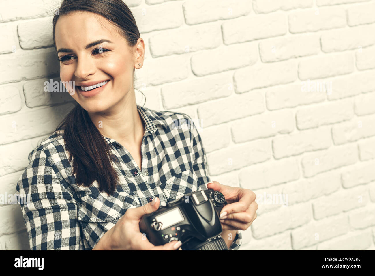 Pretty woman is a professional photographer with dslr camera Stock ...