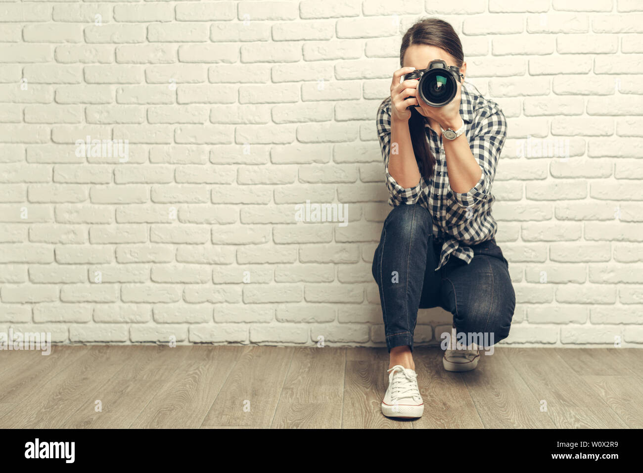 Pretty woman is a professional photographer with dslr camera Stock ...