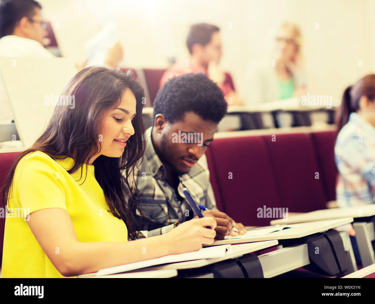 group of students with notebooks in lecture hall Stock Photo - Alamy