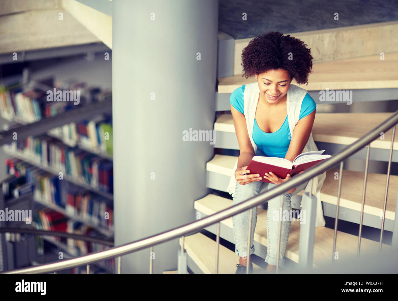 african student girl reading book at library Stock Photo - Alamy